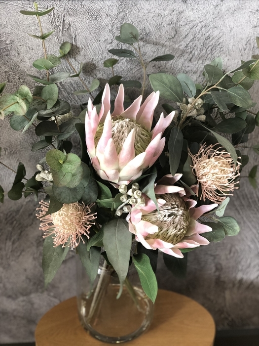 Large silk pink protea arrangement in glass vase in resin